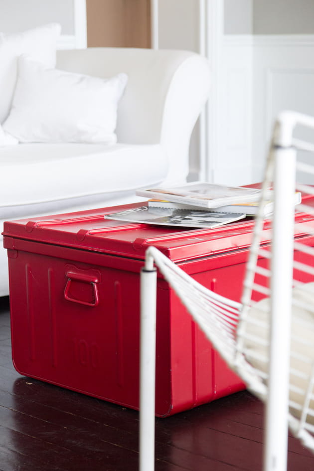 Une cantine en métal qui sert de table basse