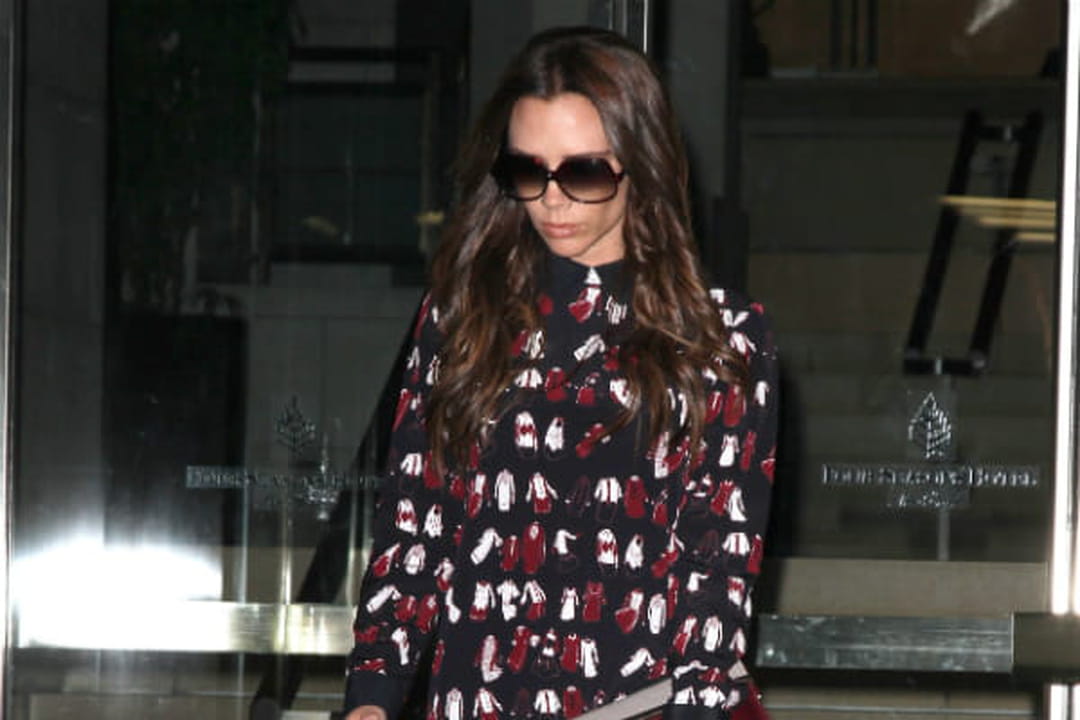 Victoria Beckham en mini robe noire à motifs et escarpins nude Louboutin