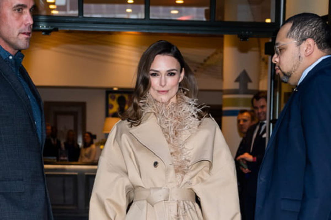 Keira Knightley en trench coat aux détails de plumes Valentino